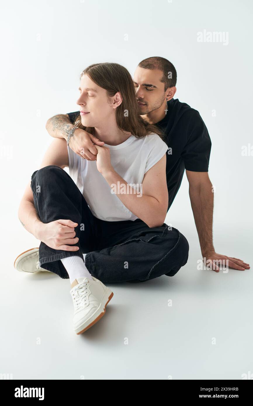 Two men sit closely together, sharing a moment of connection Stock ...