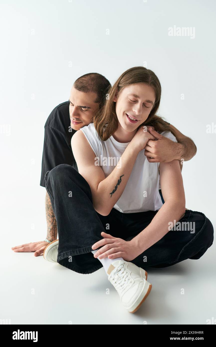 Two men sitting peacefully on the ground together Stock Photo - Alamy