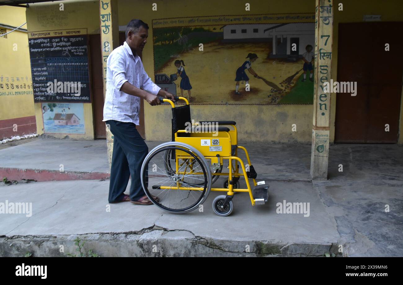 Guwahati, Guwahati, India. 25th Apr, 2024. A man bring wheel chair for ...
