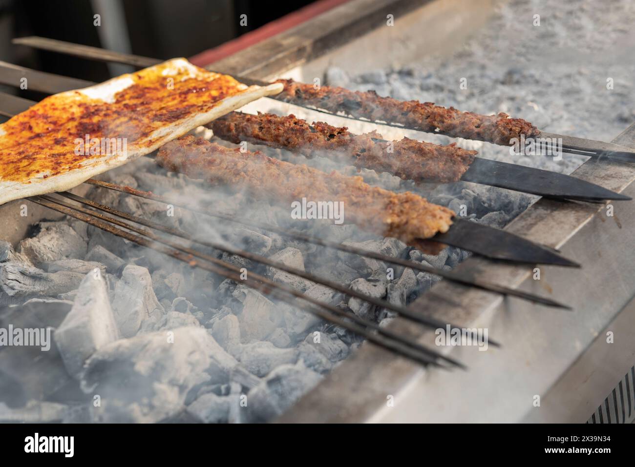 Traditional Adana kebabs with pita bread on bbq, close up, outdoor ...
