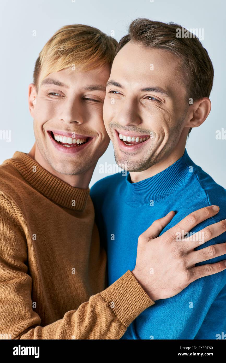 Two smiling men in casual attire hugging each other warmly Stock Photo ...