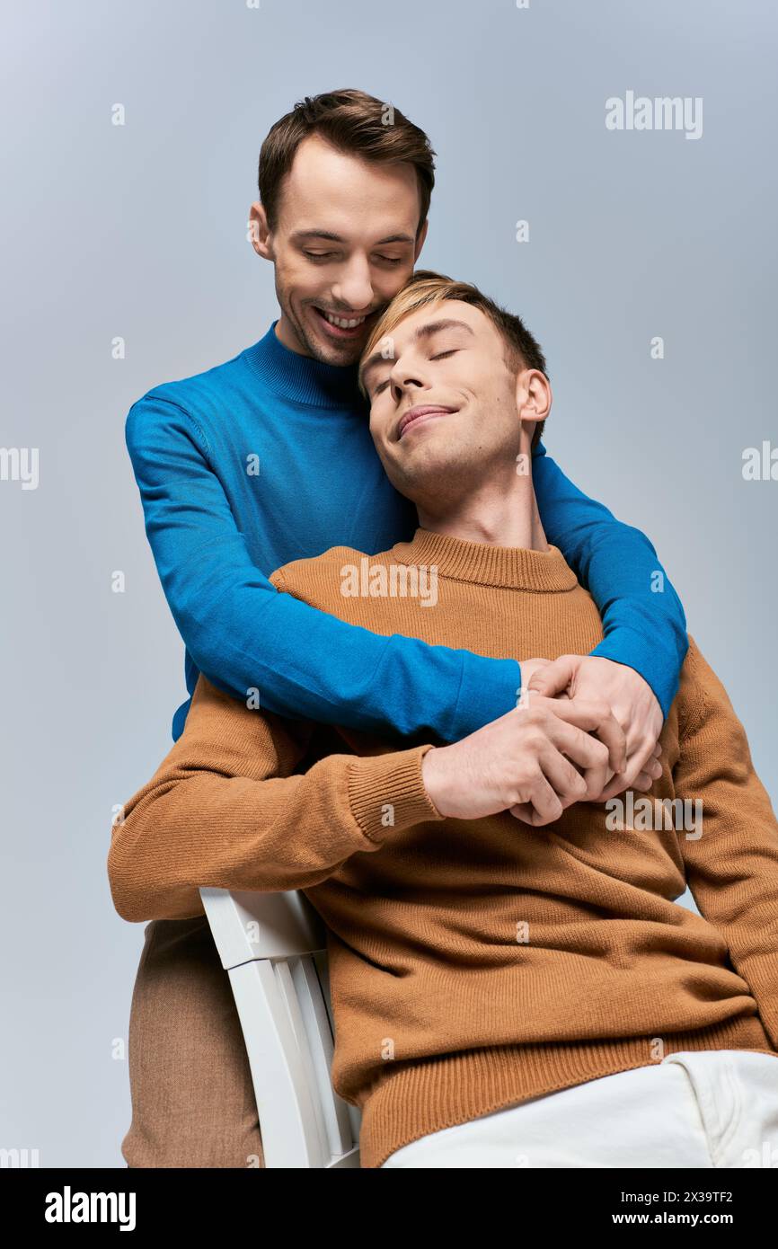 Young couple hugging chair hi-res stock photography and images - Alamy