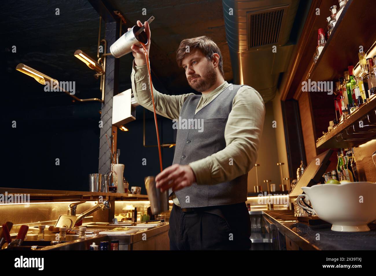 Bartender mixing cocktail using traditional shaking cups Stock Photo ...