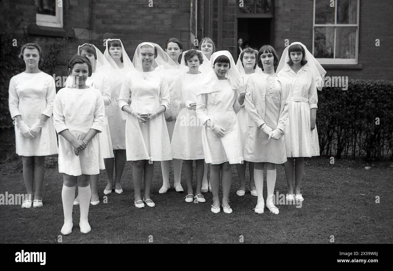 1960s, historical, a group of catholic schoolgirls, wearing the white ...