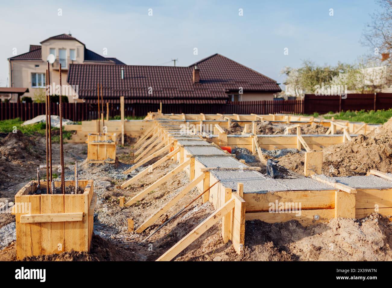 Building house. Concrete foundation surrounded with wooden decking is ...