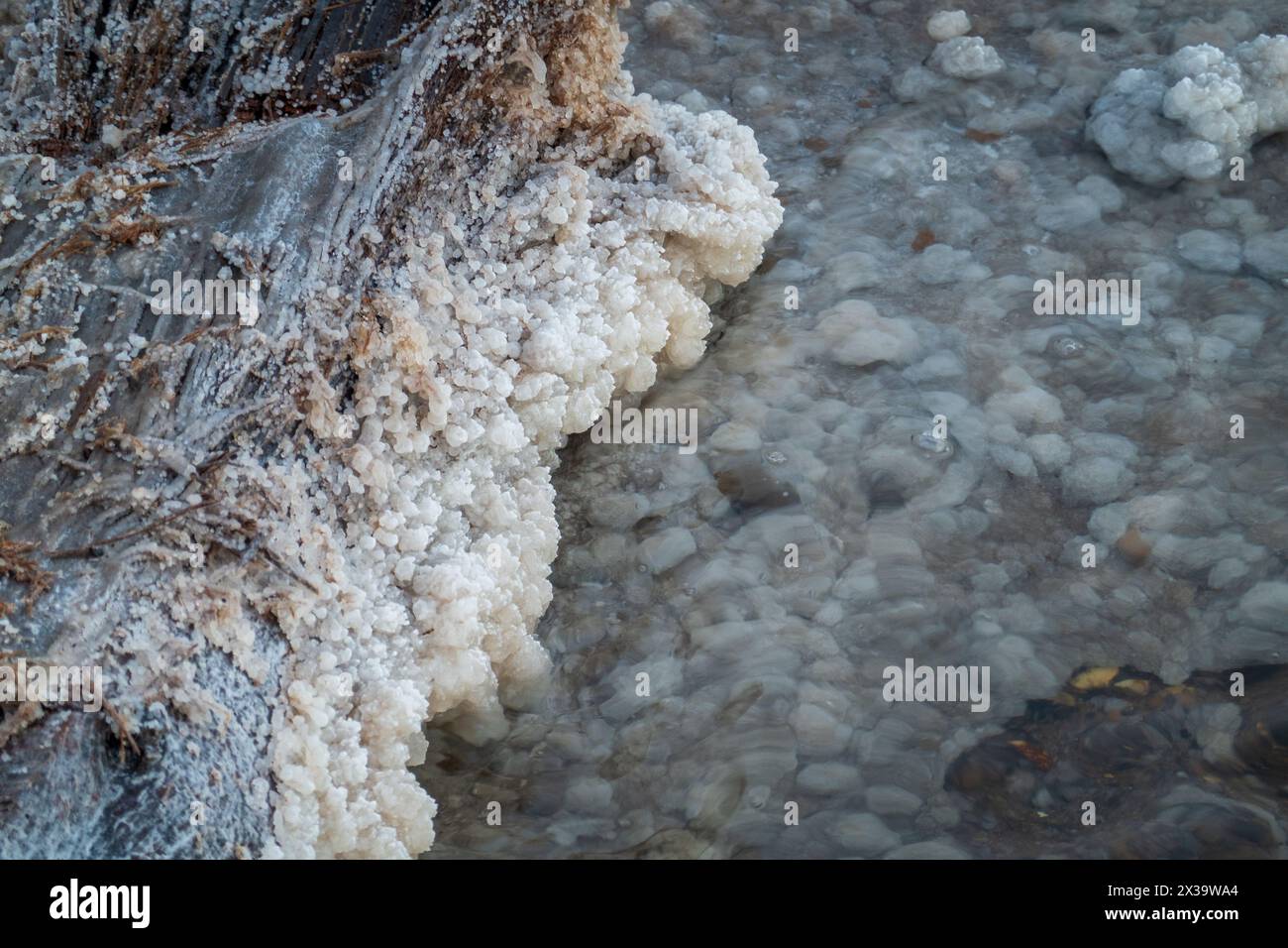 Close-up image showcasing intricate salt formations along the edge of a ...