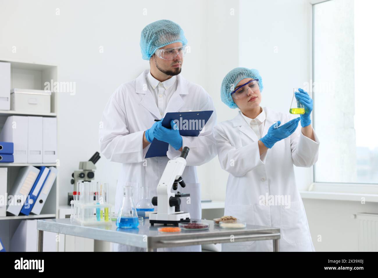 Quality control. Food inspectors checking safety of products in ...