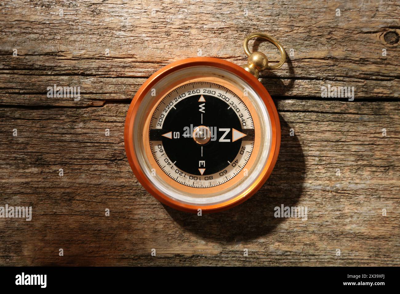One compass on wooden table, top view Stock Photo - Alamy
