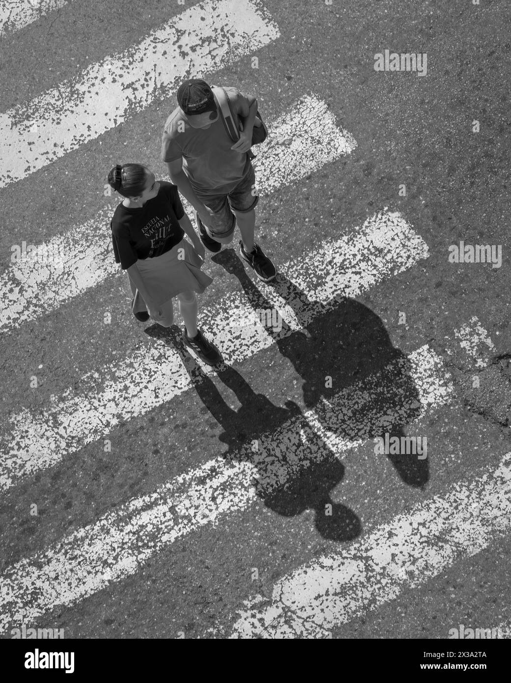 View from a rooftop, looking down on two people walking across a ...