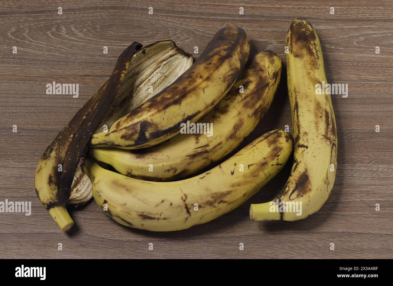 Image of four bananas in brown peel Stock Photo - Alamy
