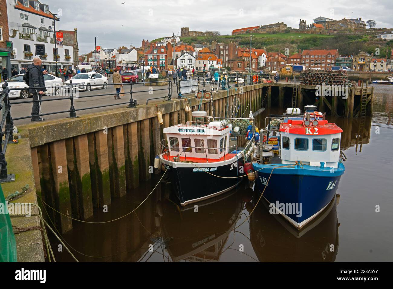 Fishing boats in the harbour of the east coast resort of Whitby, North ...