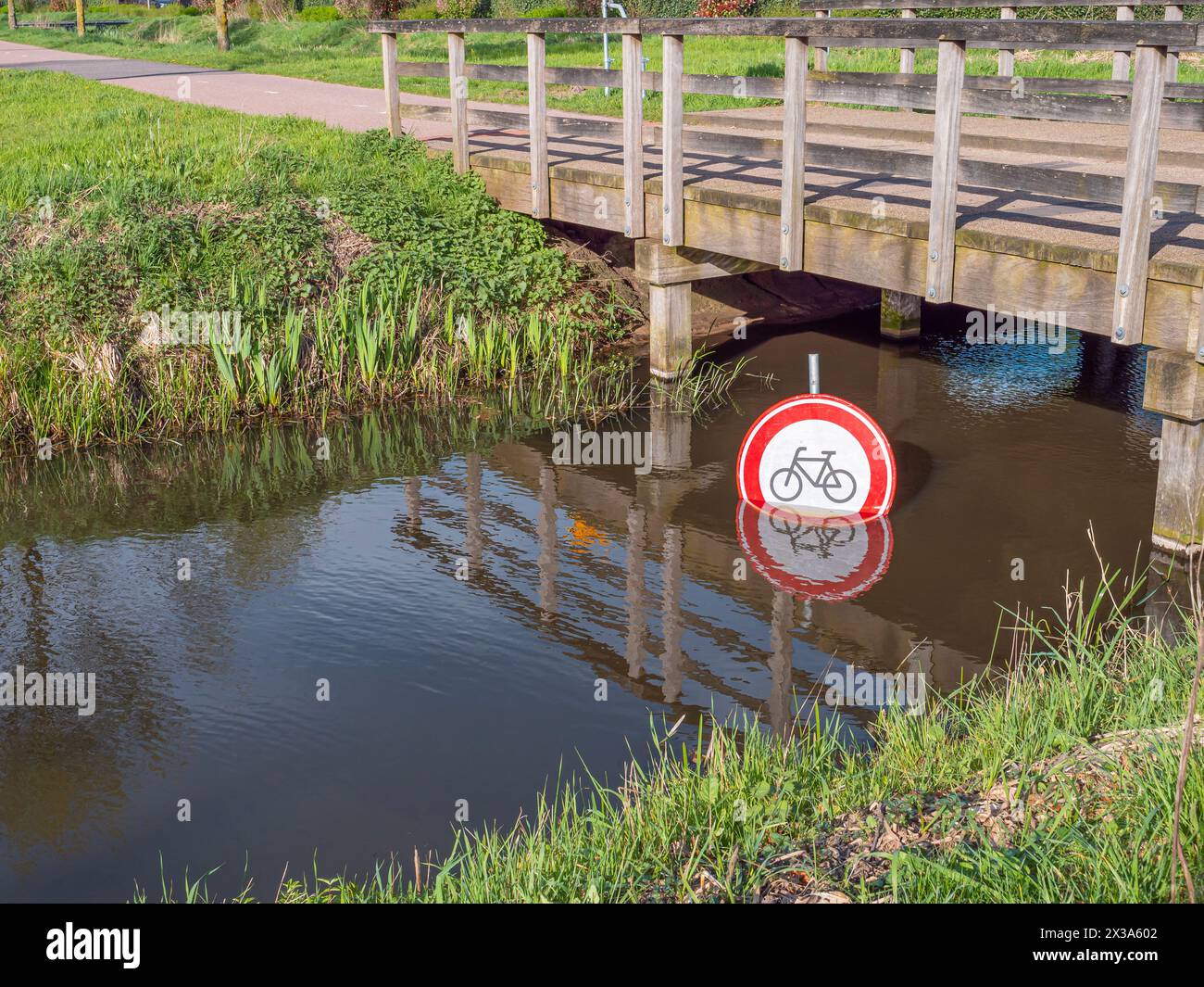 Prohibiting sign for cycling under a bridge in a water canal Stock ...