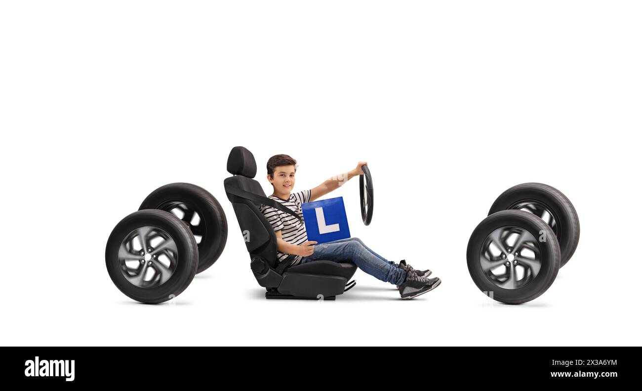 Boy sitting in a car seat and holding L plate isolated on white ...