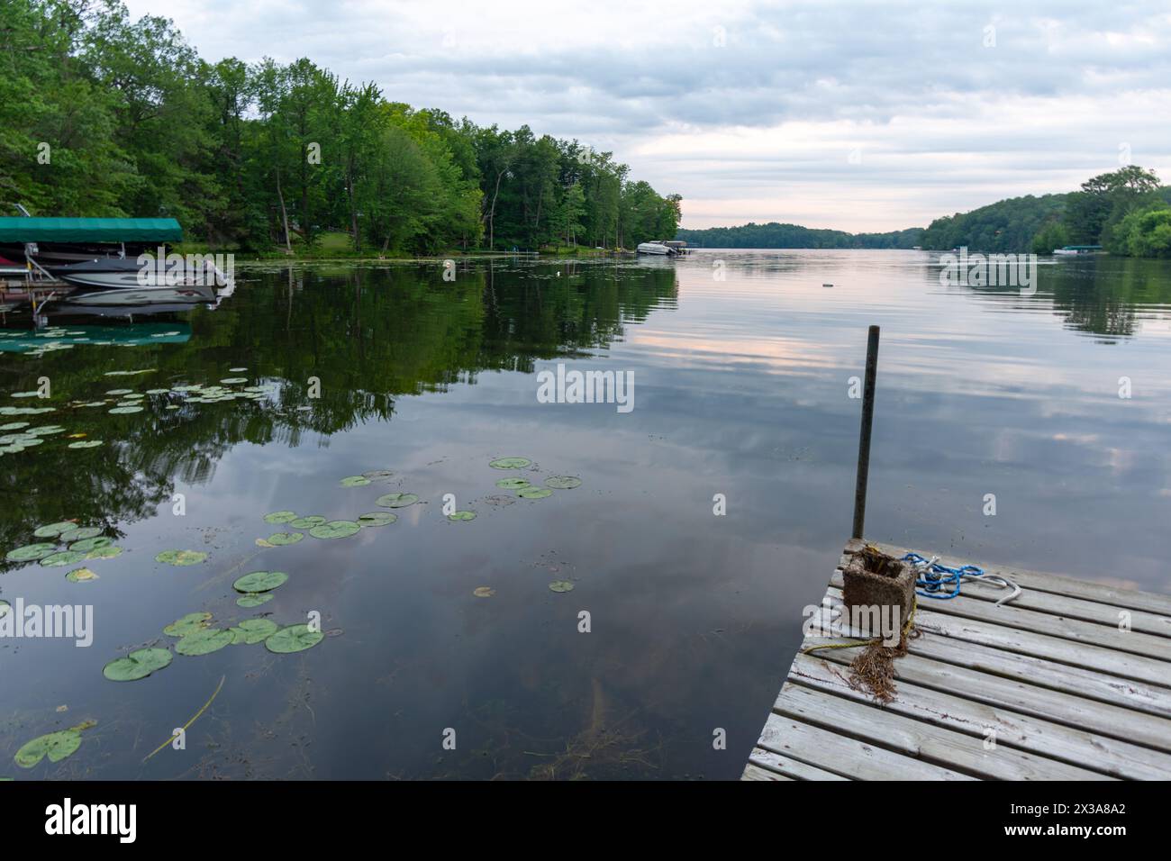 Looking off the corner of a pier on a Wisconsin Lake during dusk. Taken ...