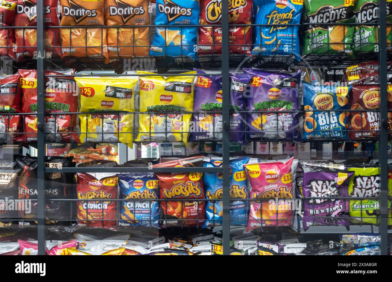 Display of packaged snacks in convenience store window Stock Photo - Alamy