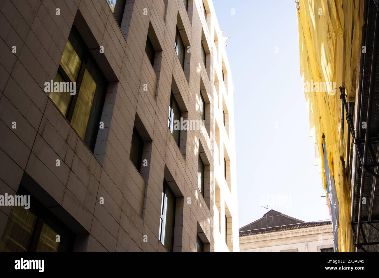 Low angle view of a building facade covered with protective yellow ...