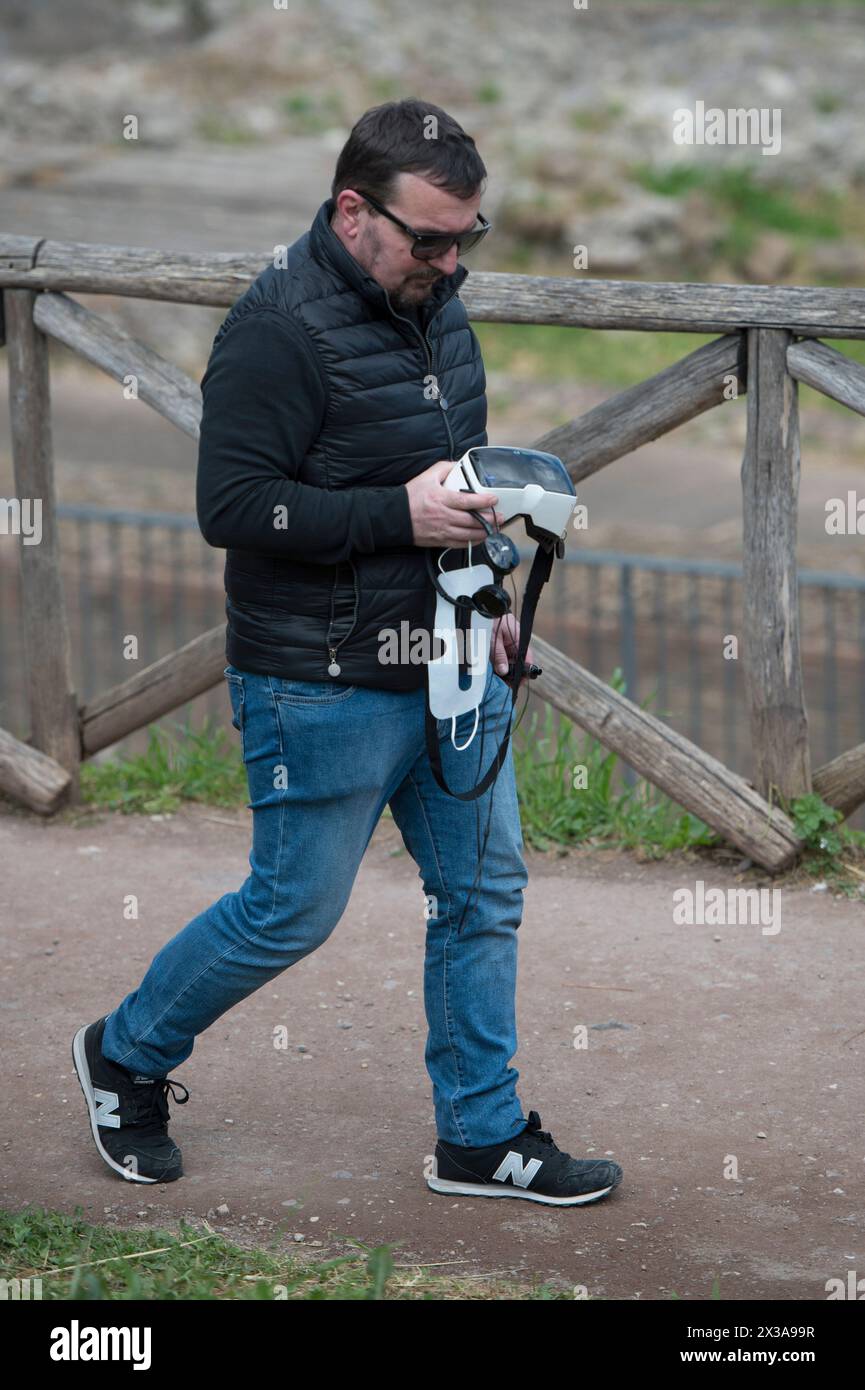Rome, Italy. 25th Apr, 2024. A tourist looks at the augmented reality ...
