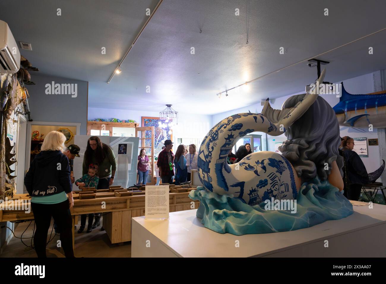 Visitors enjoy the exhibit at the International Mermaid Museum during ...