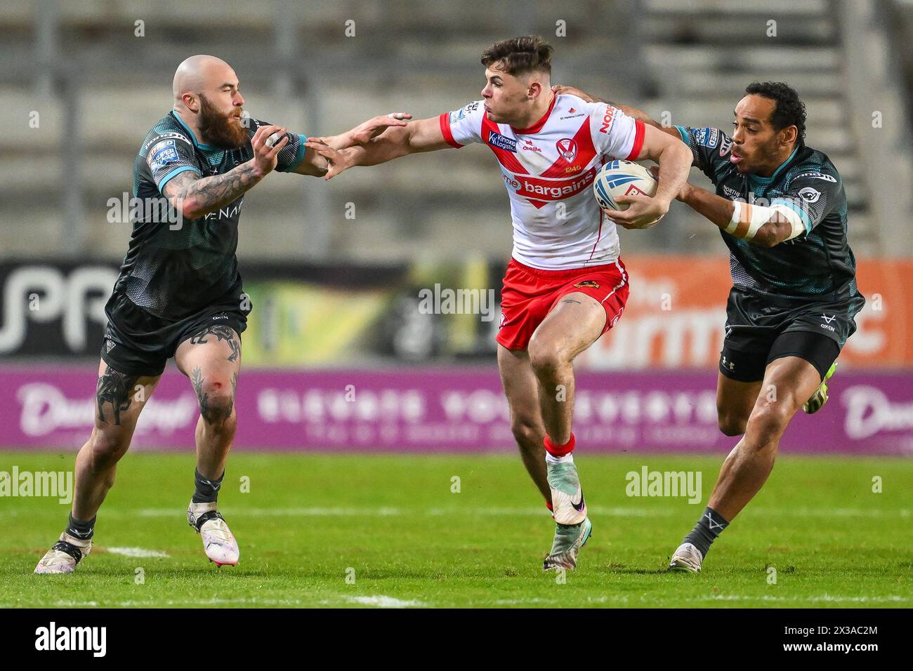 Jack Welsby of St. Helens fends off Jake Bibby of Huddersfield Giants ...