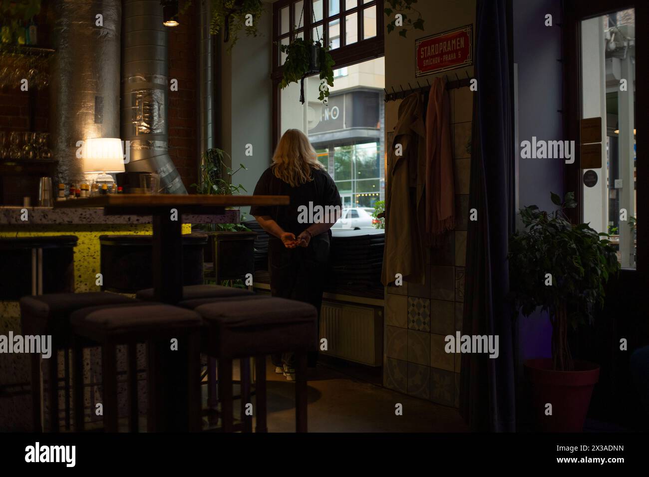 Warsaw, Poland. 25th Apr, 2024. A waitress at a restaurant bar is seen ...