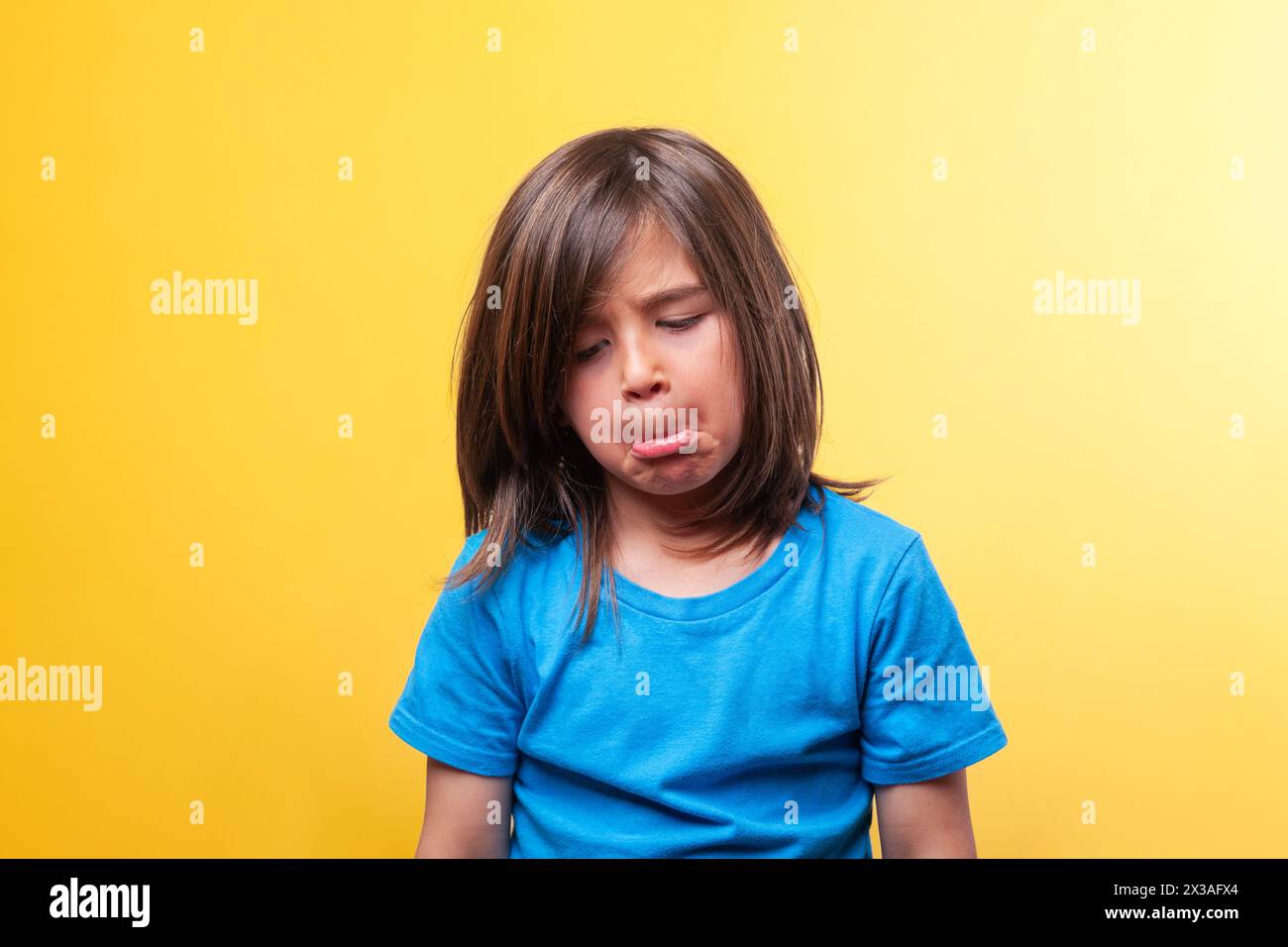 Boy in a blue T-shirt Shows a great face of sadness and grief. Concept ...