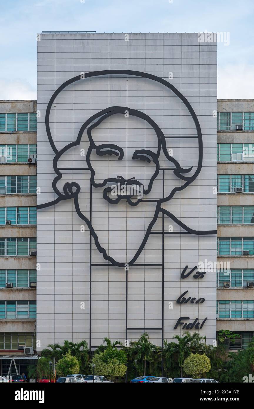 A large iconic portrait of Camilo Cienfuegos in front of a building on ...
