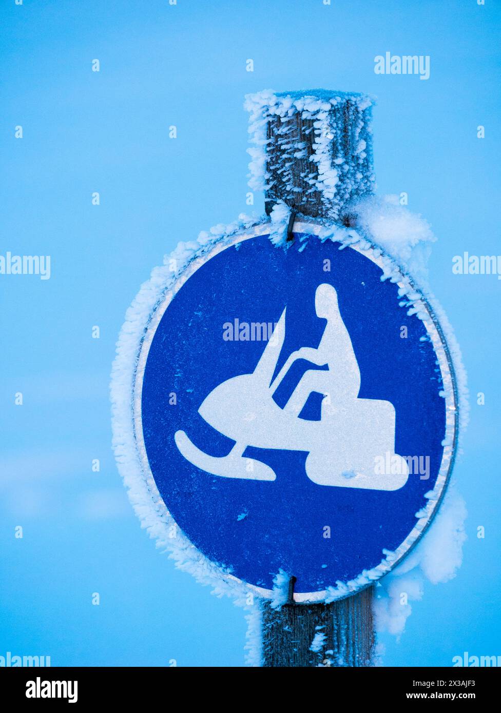 Blue sign with white silhouette of one person on a skidoo, snowscooter ...