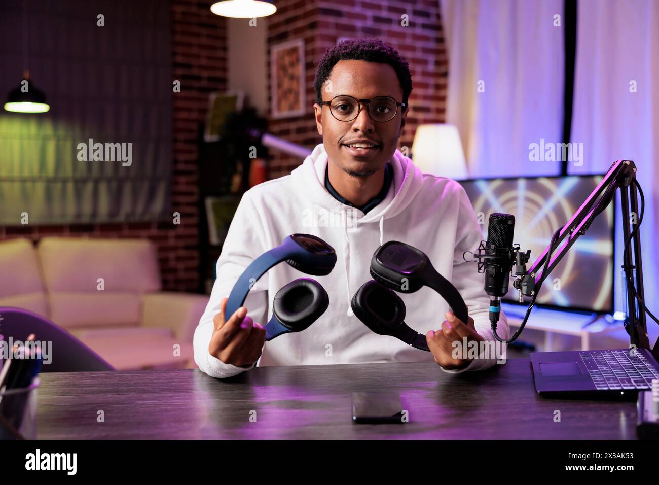 Portrait of technology reviewer recording headphones comparison episode ...