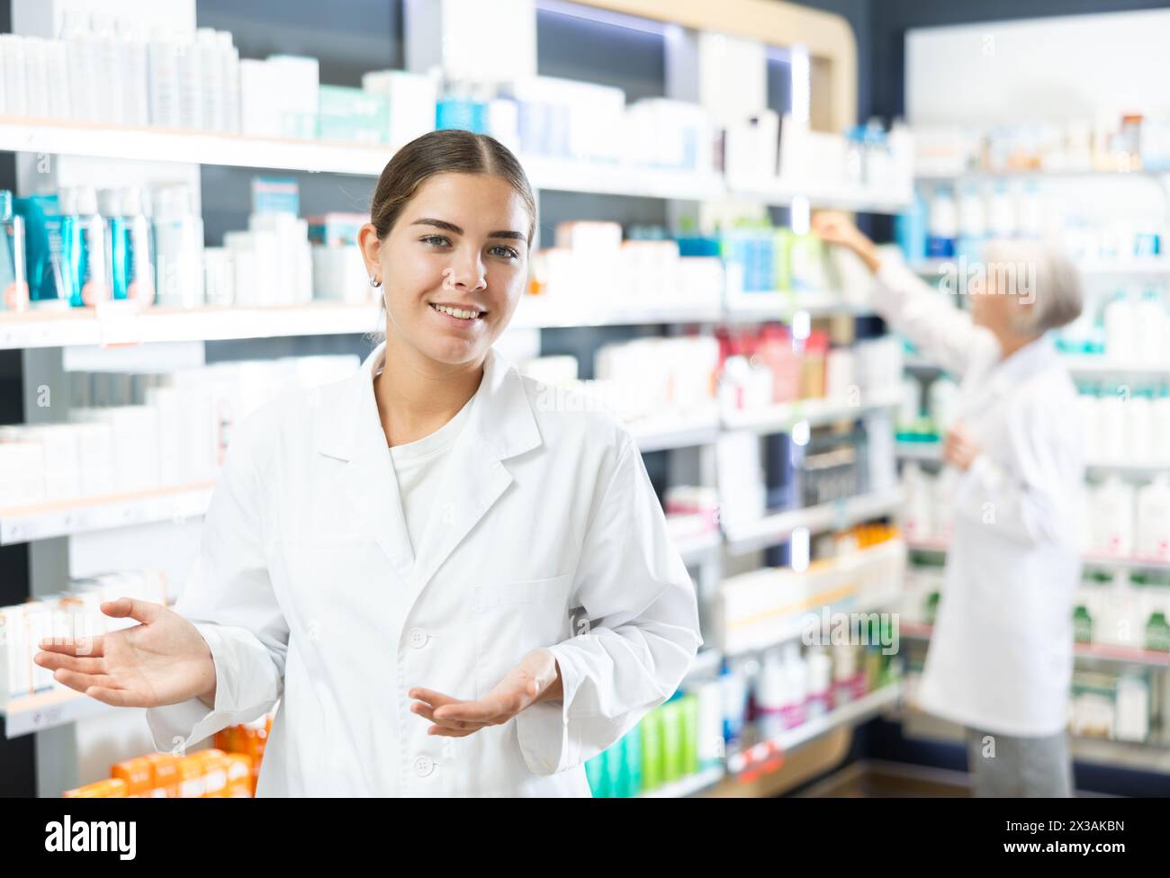 Female pharmacist in medical uniform posing while working in pharmacy ...