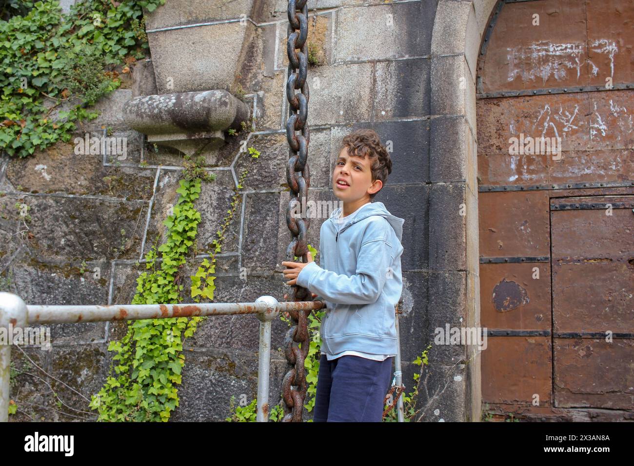 boy in the door of an abandoned castle. San Felipe castle in Ferrol ...