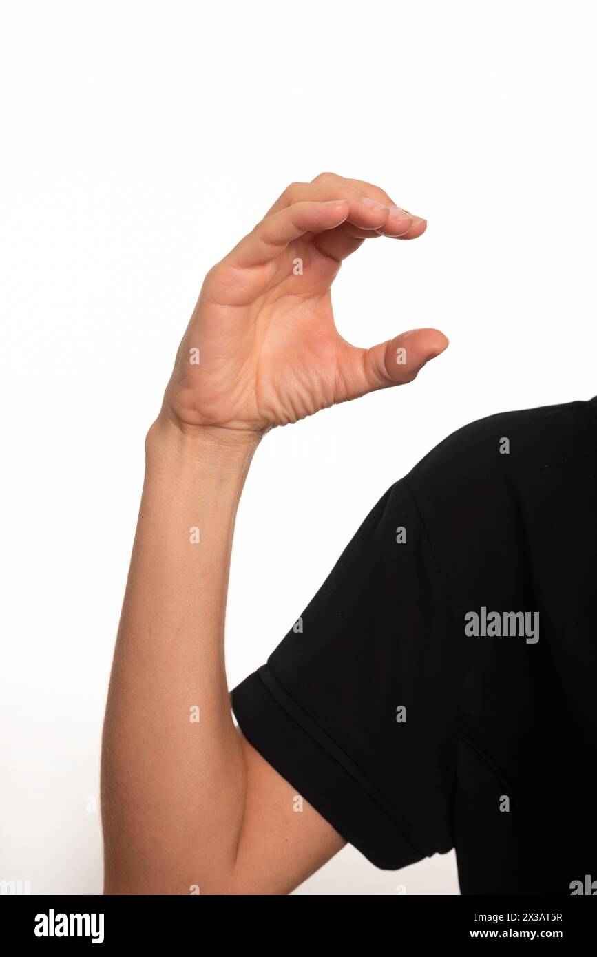 Close-up of a female arm and hand making the letter C in the Brazilian ...