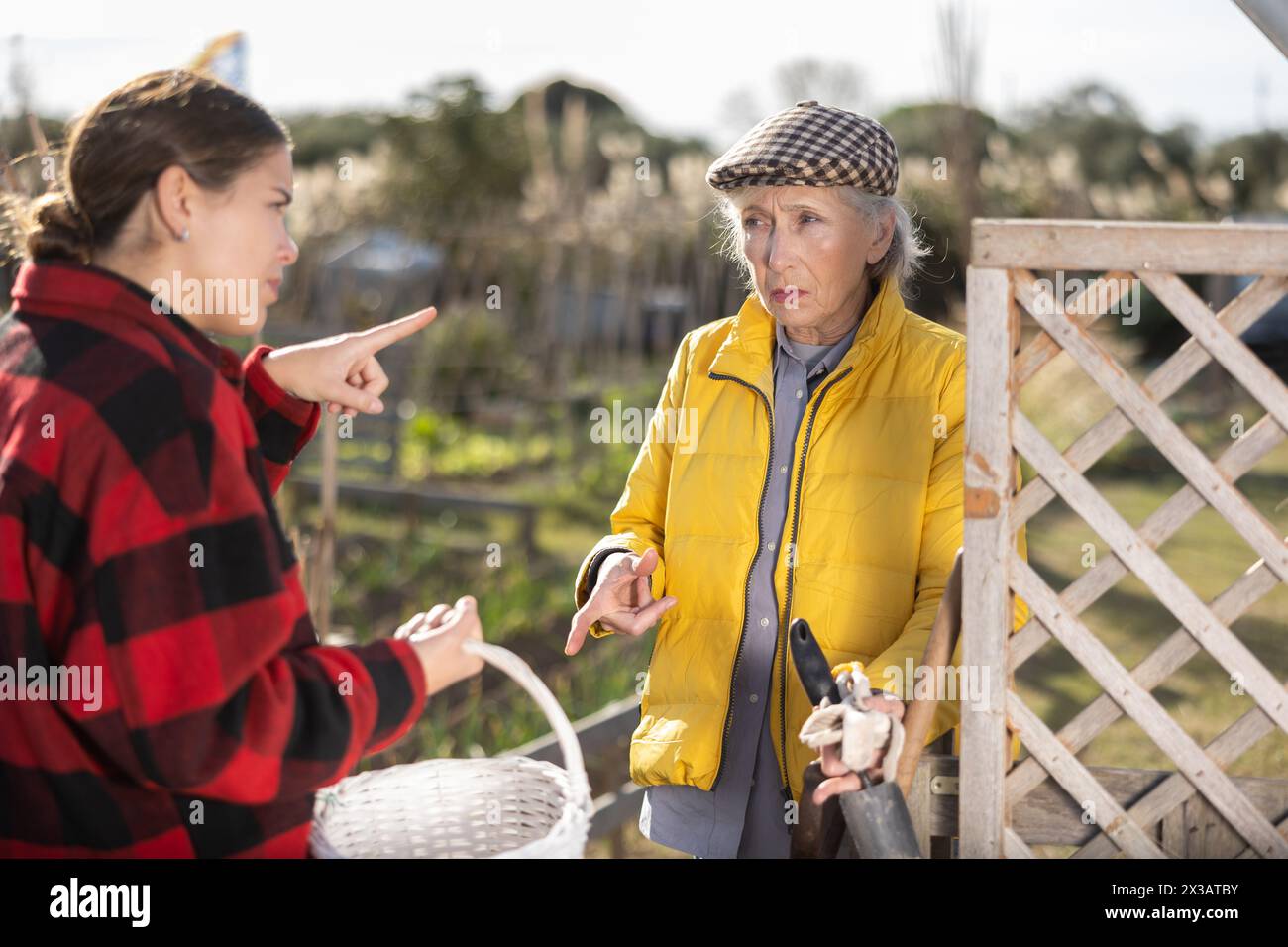 Women argue garden fence hi-res stock photography and images - Alamy