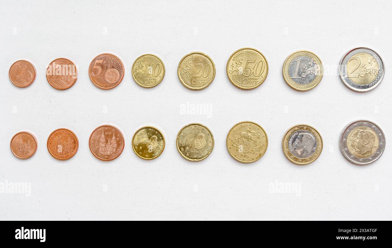 Euro coins in increasing order according to their value on white ...