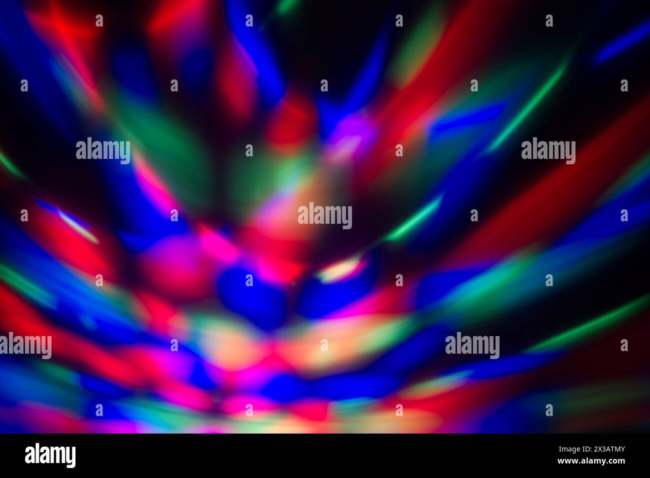 Abstract photograph of moving coloured lights forming an explosion of ...