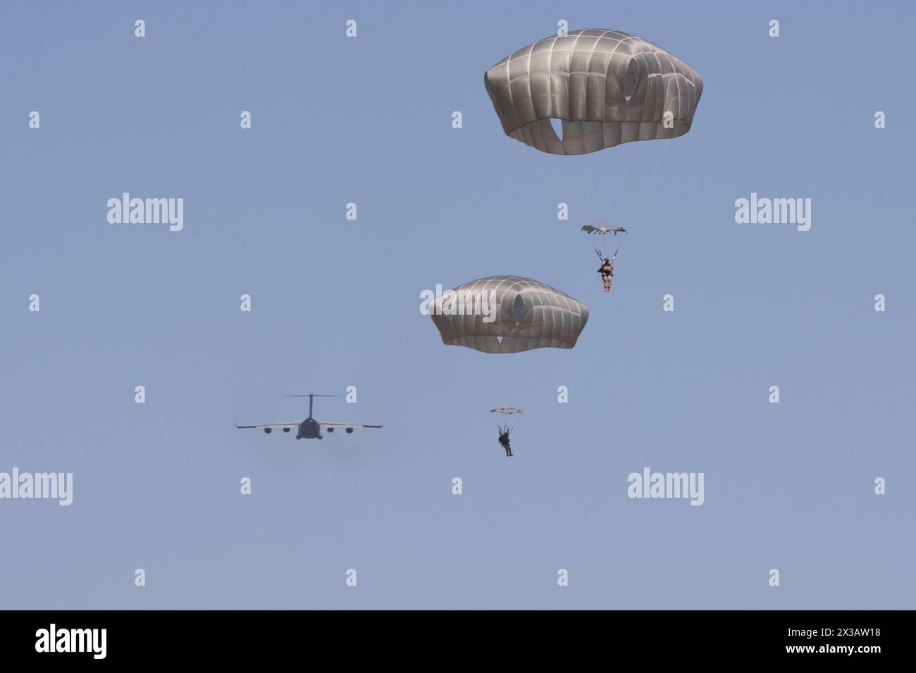 U.S. Army Soldiers conduct static line airborne jumps out of a C-17 ...