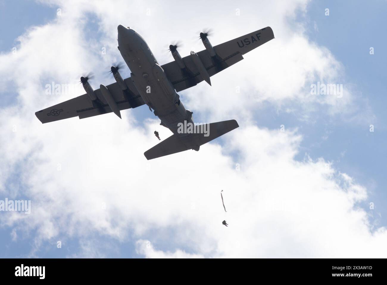 A U.S. Army Soldier conducts a static line airborne jump out of a C-130 ...