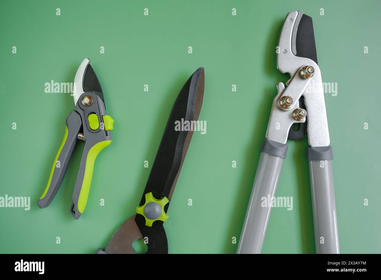 Pruning Tool. Secateurs, loppers and hedge trimmers on a green combined ...