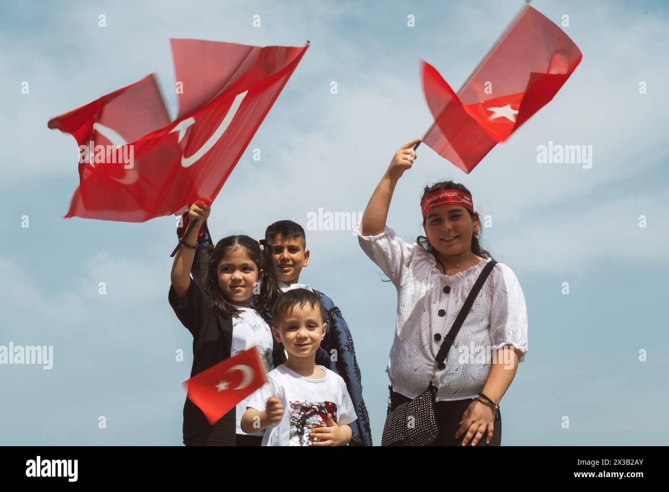 Izmir, Turkey - April 23, 2024: Joyful children wave the Turkish flag ...