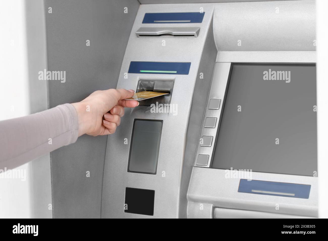 Woman inserting credit card into grey cash machine, closeup Stock Photo ...
