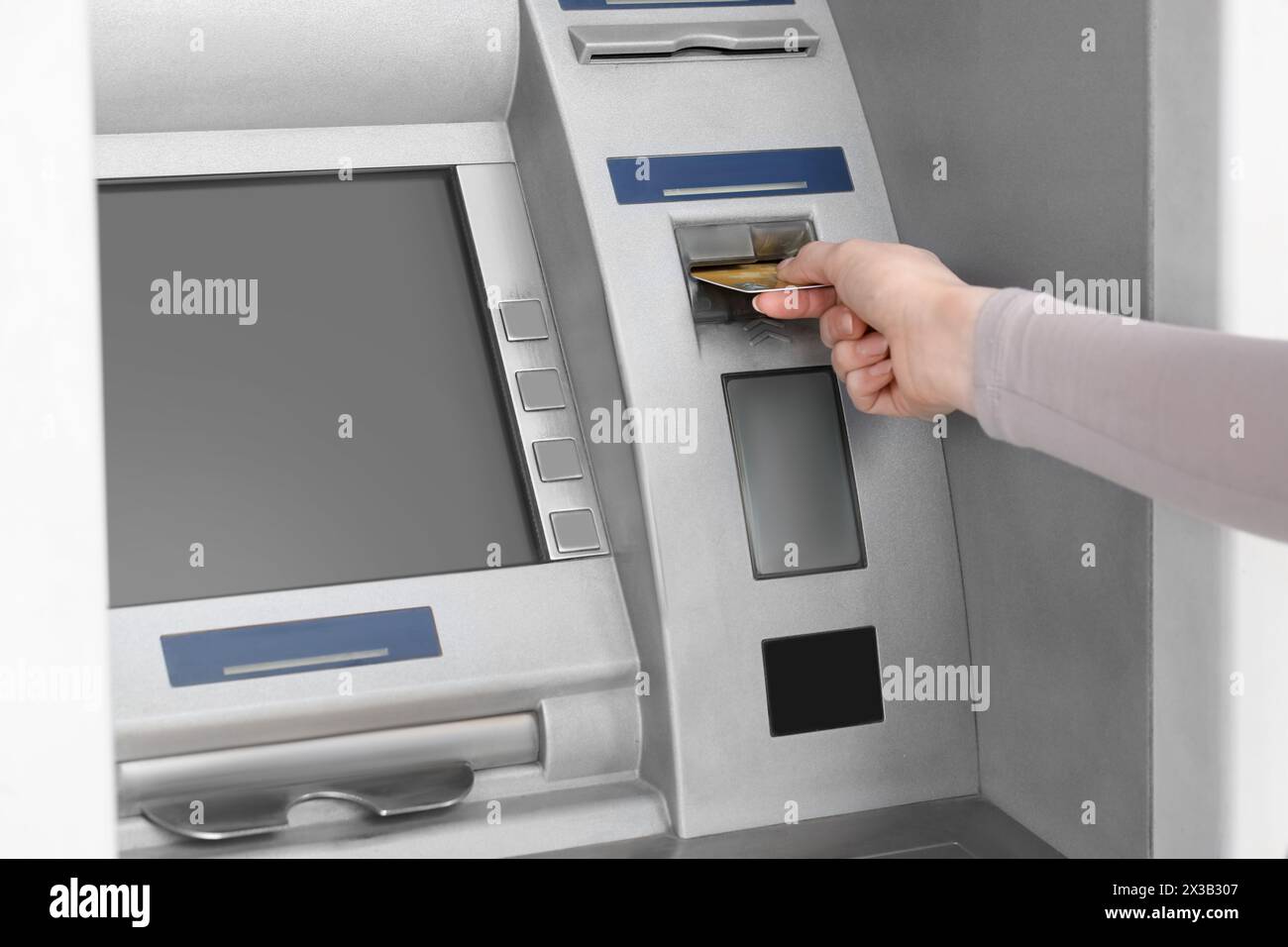 Woman inserting credit card into grey cash machine, closeup Stock Photo ...