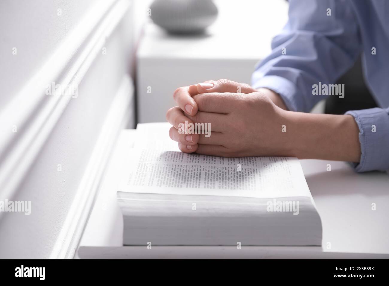 Religion. Christian woman praying over Bible indoors, closeup Stock ...