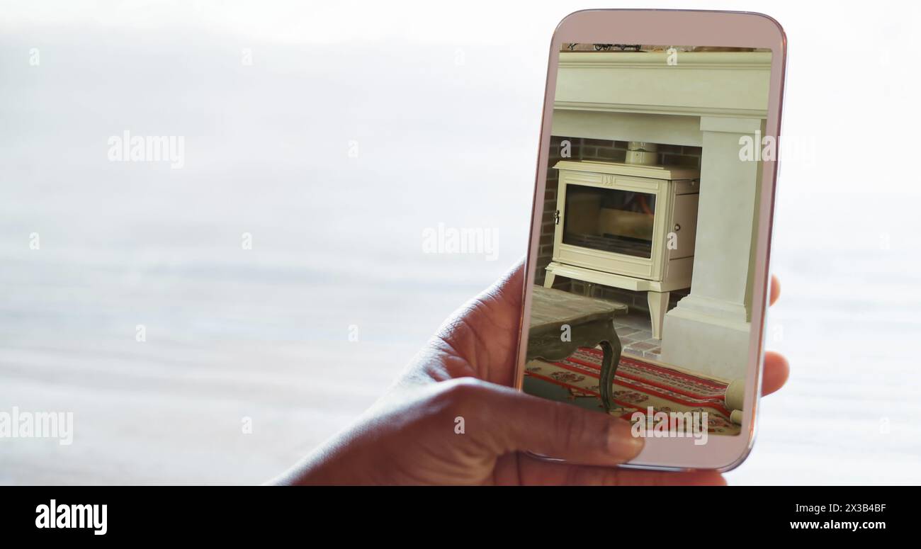Image of person using smartphone with house sitting room fireplace ...