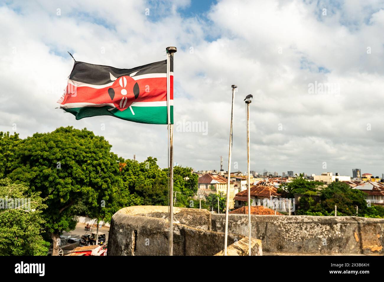 Kenya flag waving in the wind against the background of a blue cloudy ...