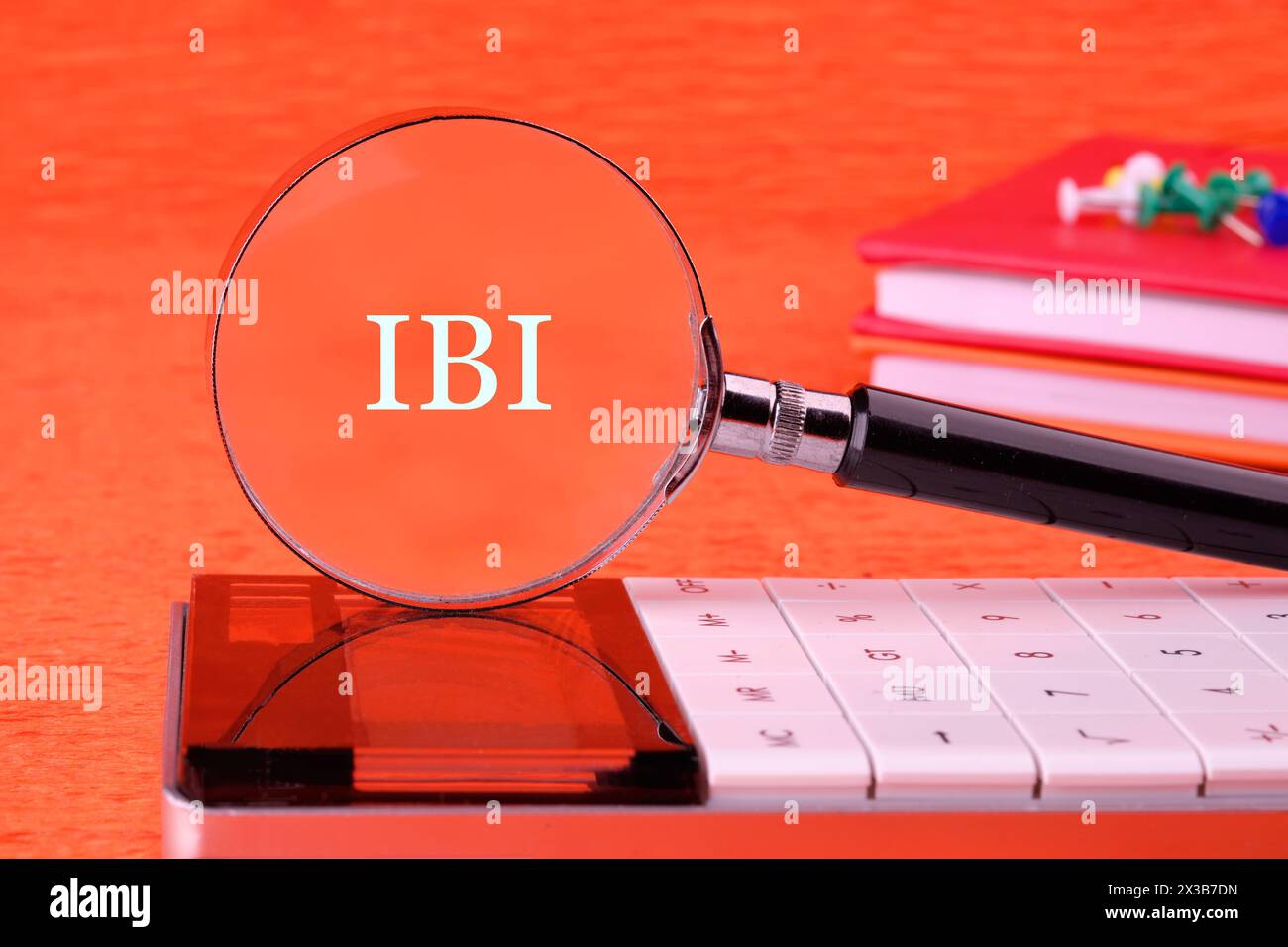 IBI symbol through a magnifying glass in white font on an orange ...