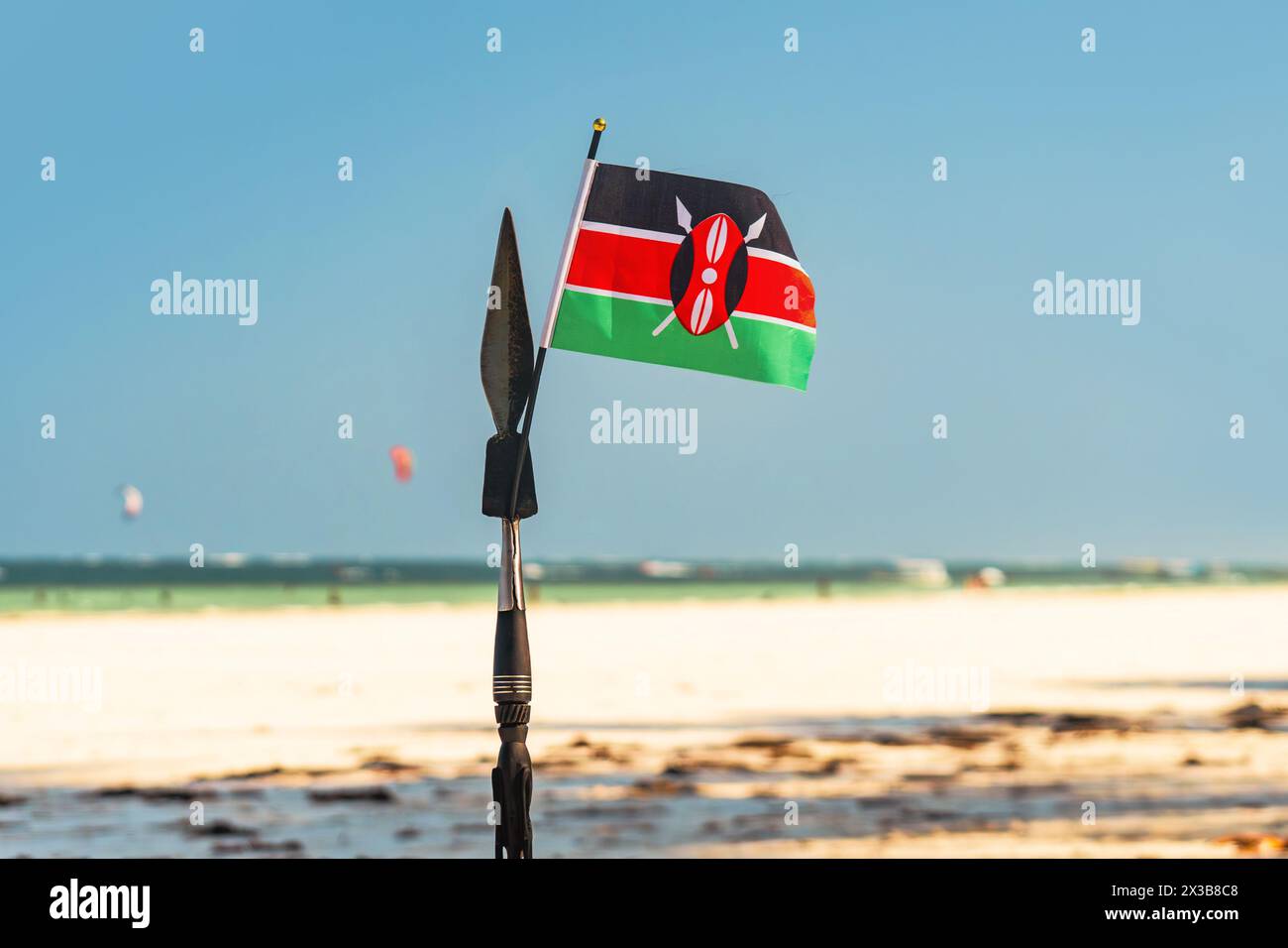 The spear of Masai and the national flag of Kenya on the background of ...