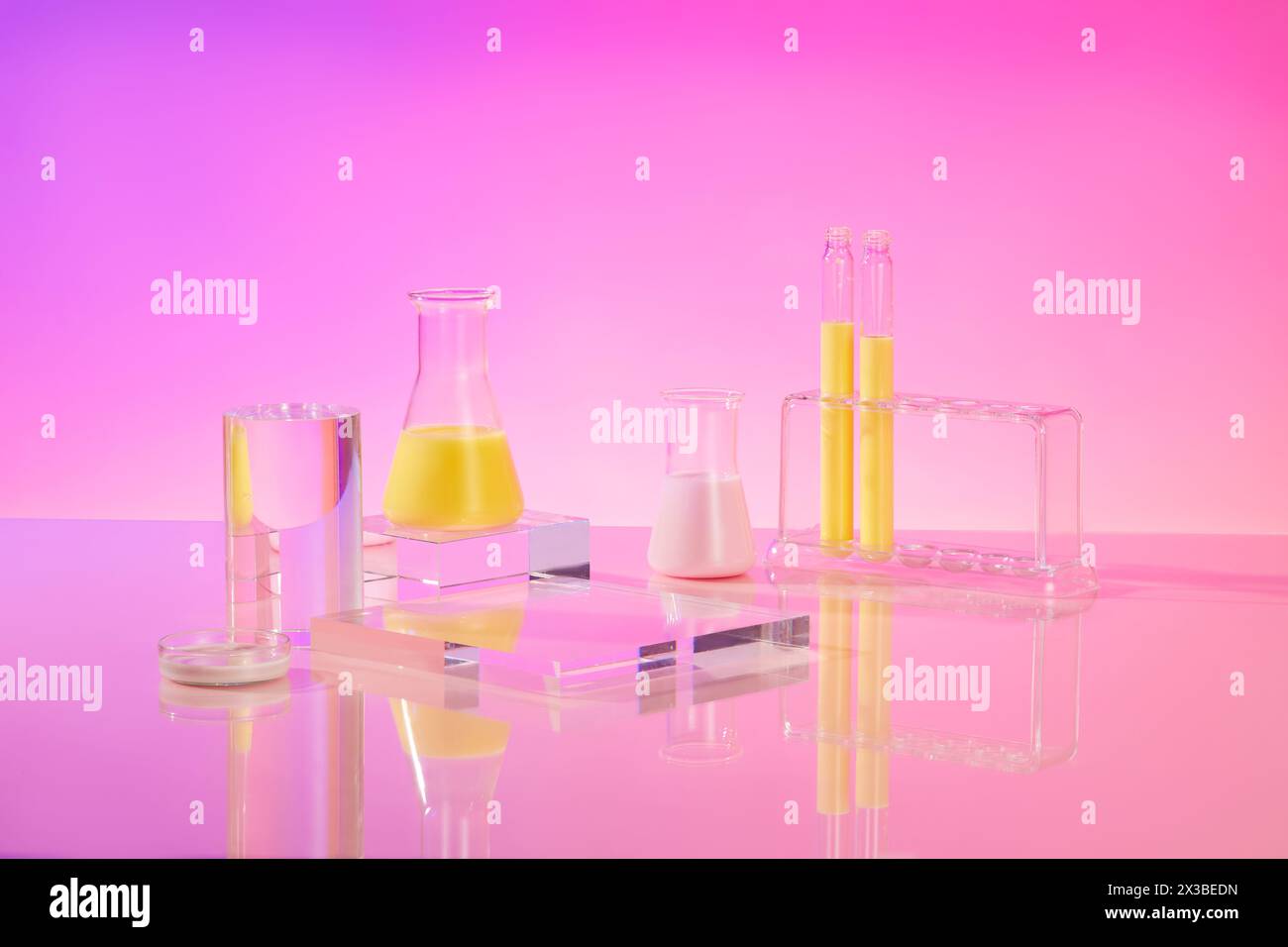 Erlenmeyer flasks and test tubes of yellow liquid displayed over ...