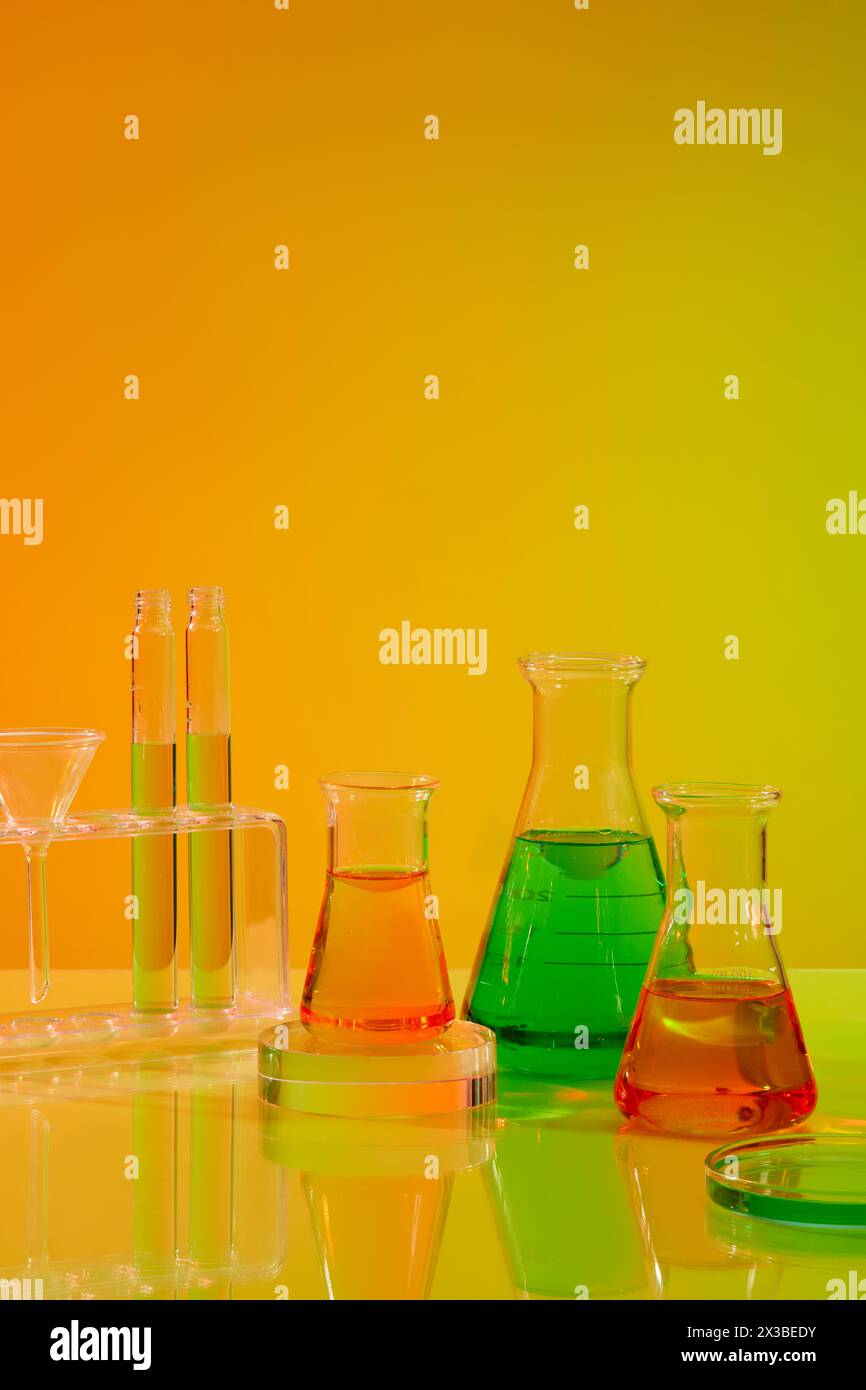 Three erlenmeyer flasks and a petri dish filled with liquid in ...