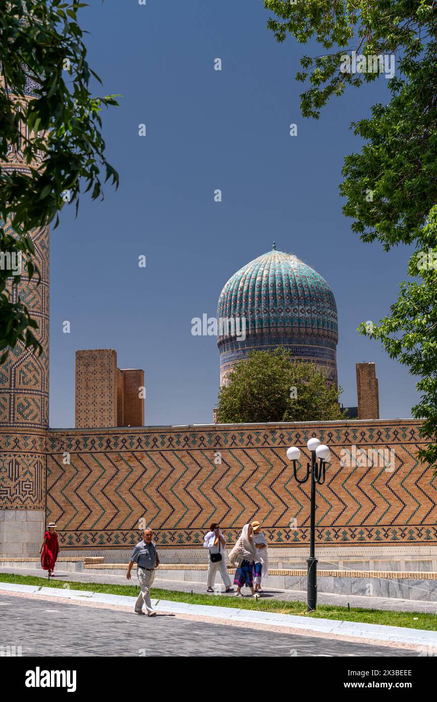 The view of lady walking in front of Bibi Khanym mosque in Samarqand ...