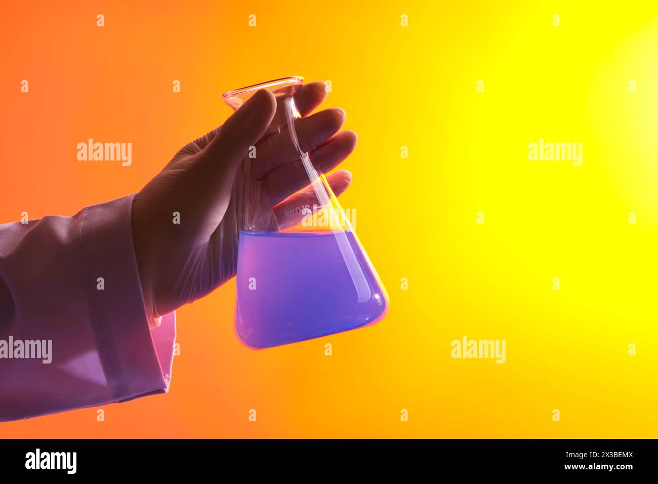 Minimal scene of a female scientist with medical glove holding a beaker ...