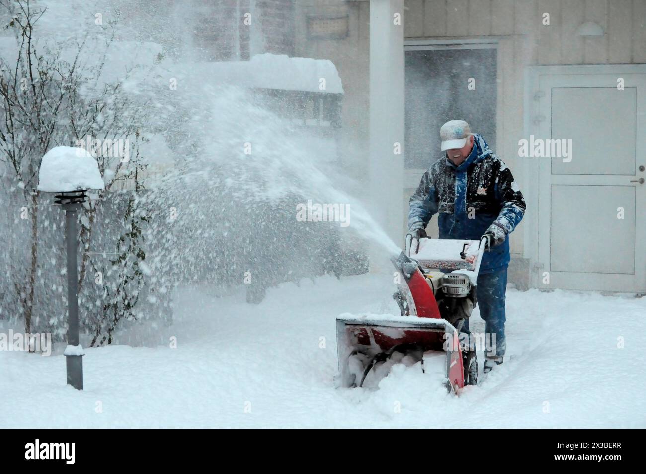 Man with snowblower clearing snow, Ystad, Scania, Sweden, Scandinavia ...